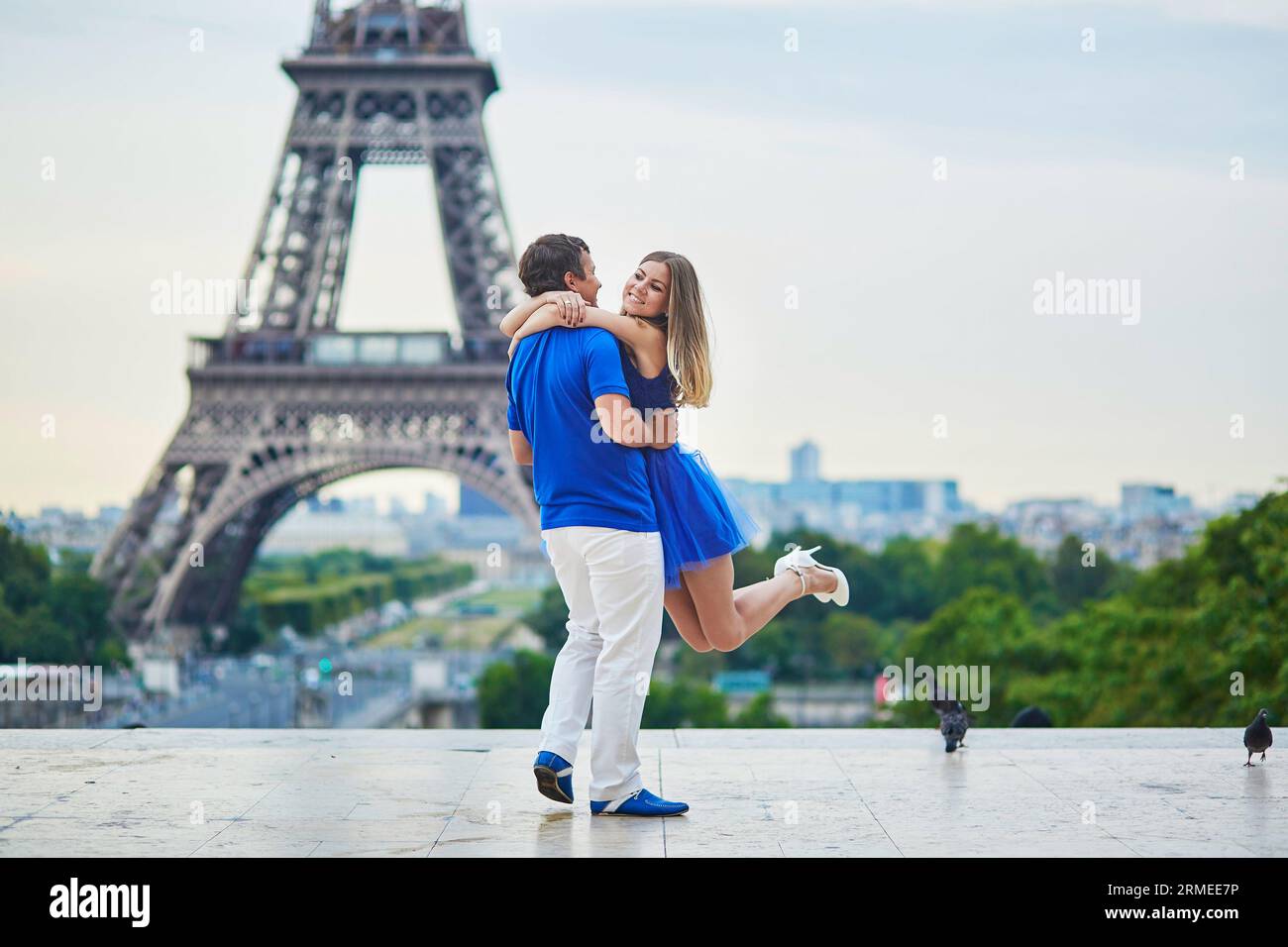 Romantic dating couple on Trocadero viewpoint in Paris, man is rotating ...