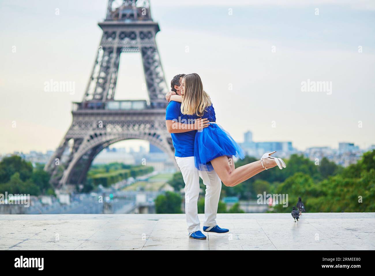 Romantic dating couple on Trocadero viewpoint in Paris, man is rotating ...