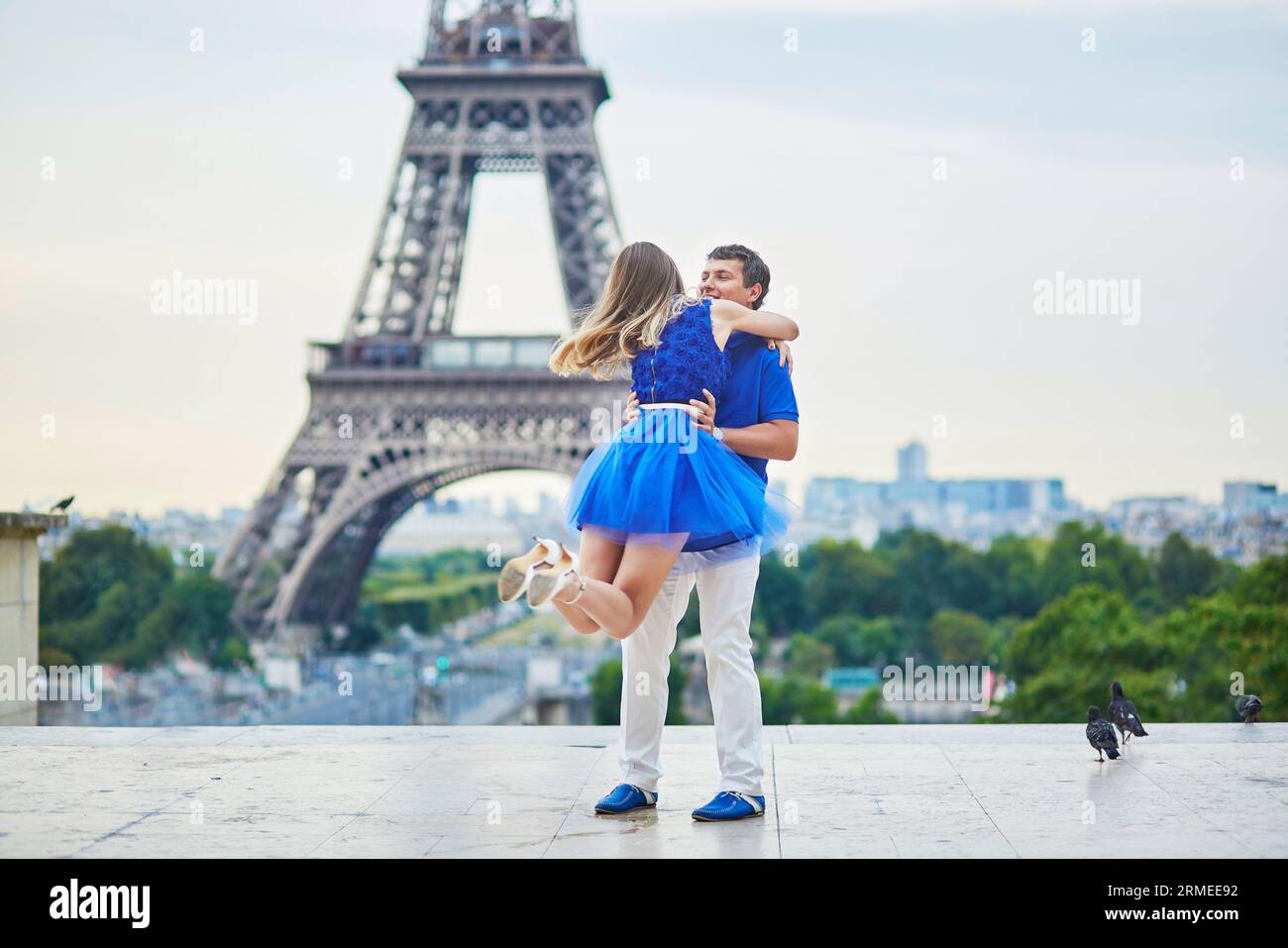 Romantic dating couple on Trocadero viewpoint in Paris, man is rotating ...
