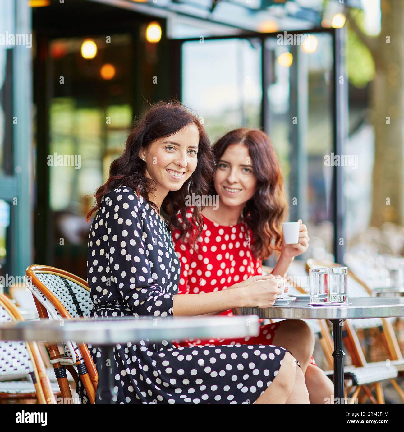 Twin sisters drinking coffee in Paris. Tourists enjoying their vacation ...