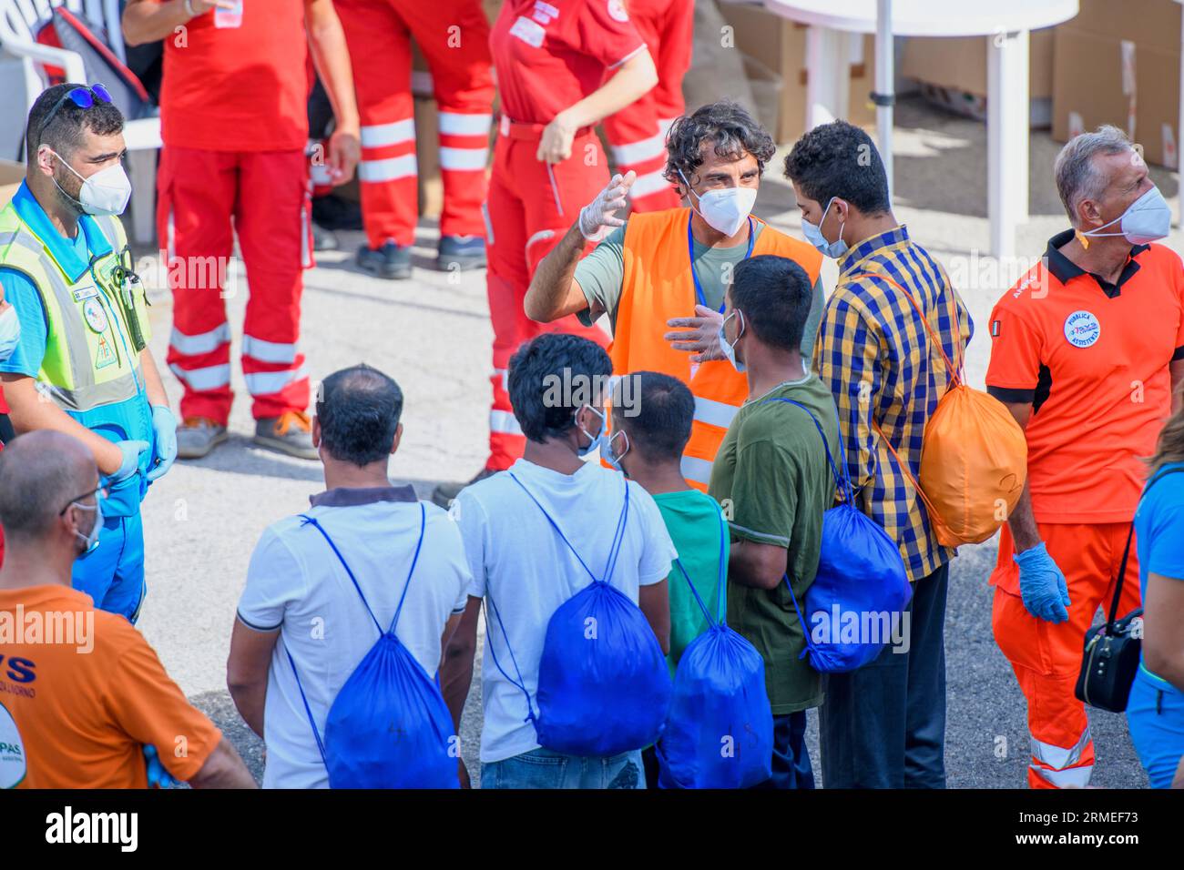 Livorno, Italy. 27th Aug, 2023. A Red Cross operator gives instructions ...