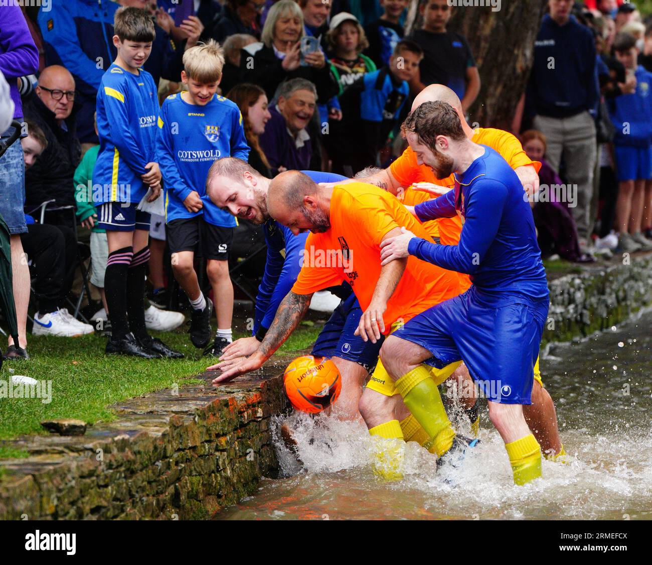 Footballers from Bourton Rovers fight for the ball during the annual ...