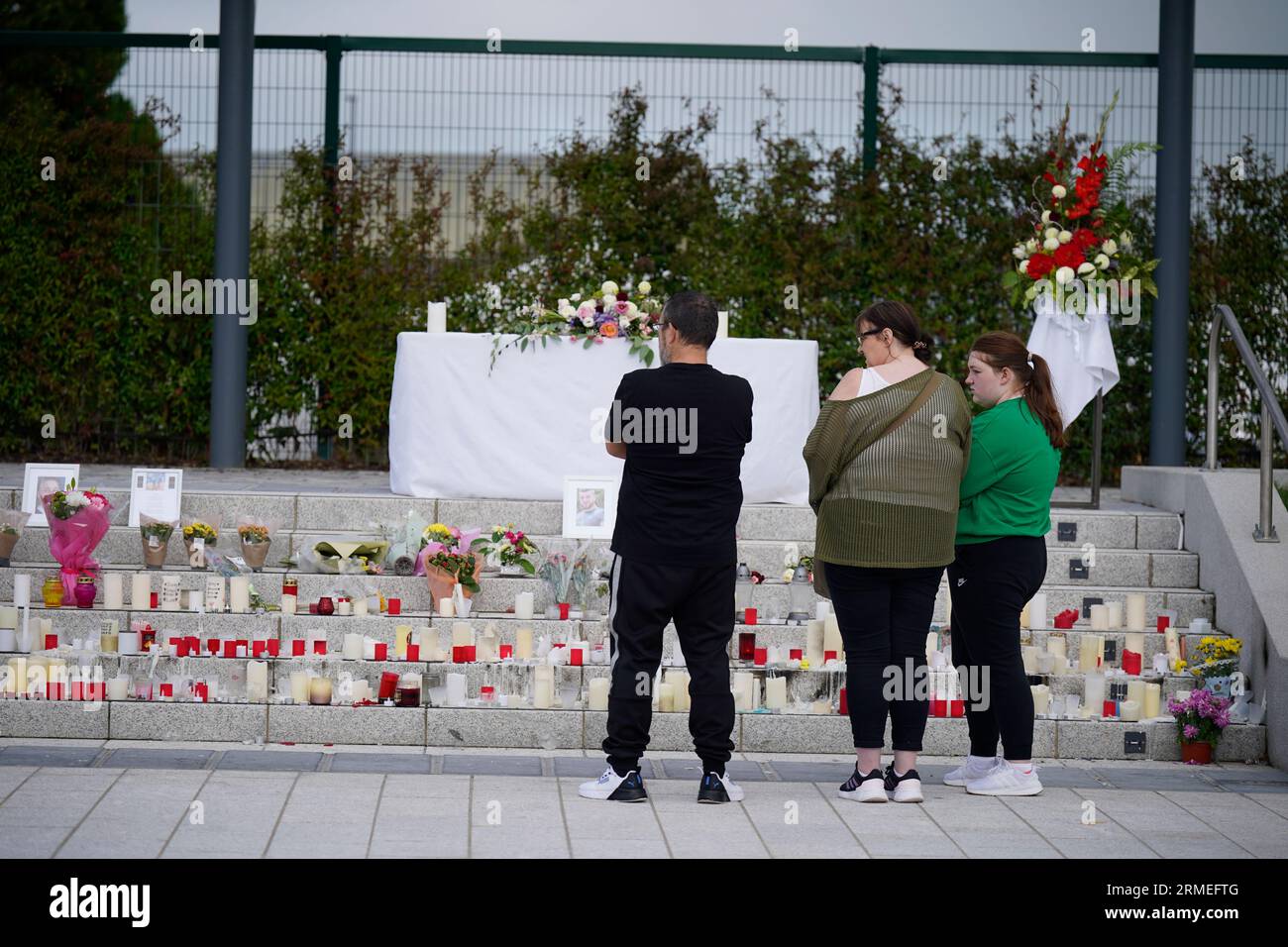People look at the tributes left at Kickham Plaza, Co Tipperary, in ...
