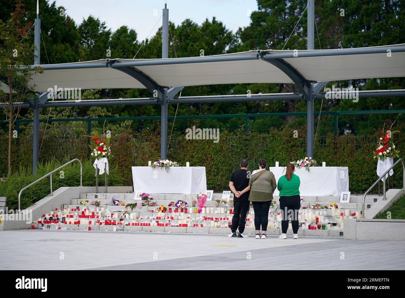 People look at the tributes left at Kickham Plaza, Co Tipperary, in ...
