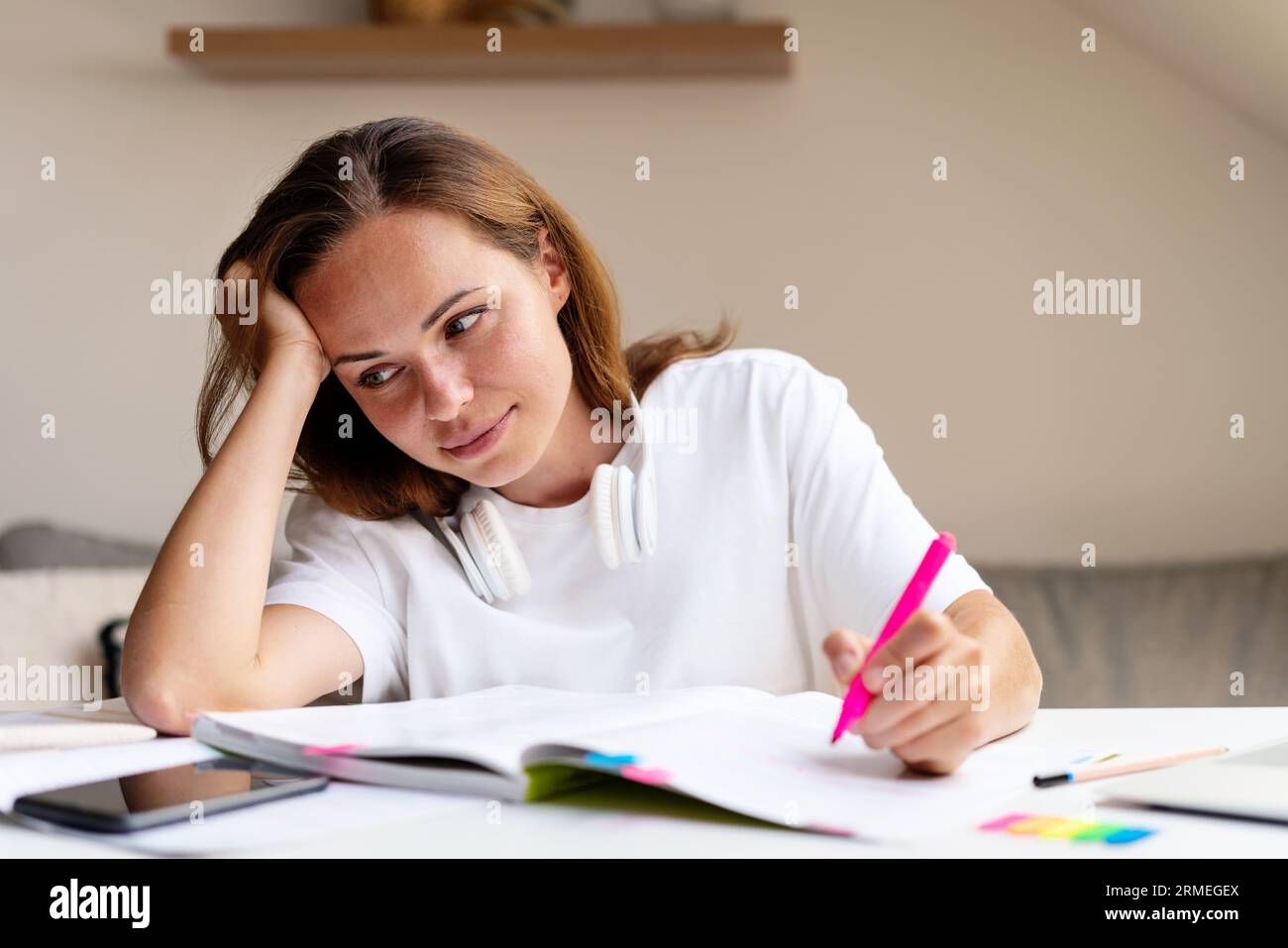 Tired female university student doing homework at home Stock Photo - Alamy