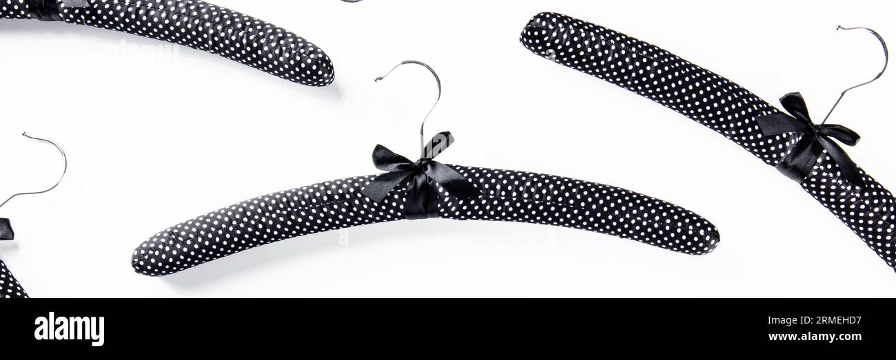 Fashion collection panorama. Black satin hangers for delicate clothes ...