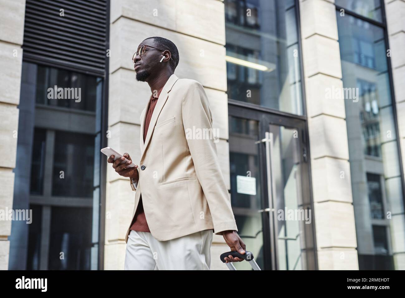 Busy young male ceo in quit luxury attire listening to music in ...