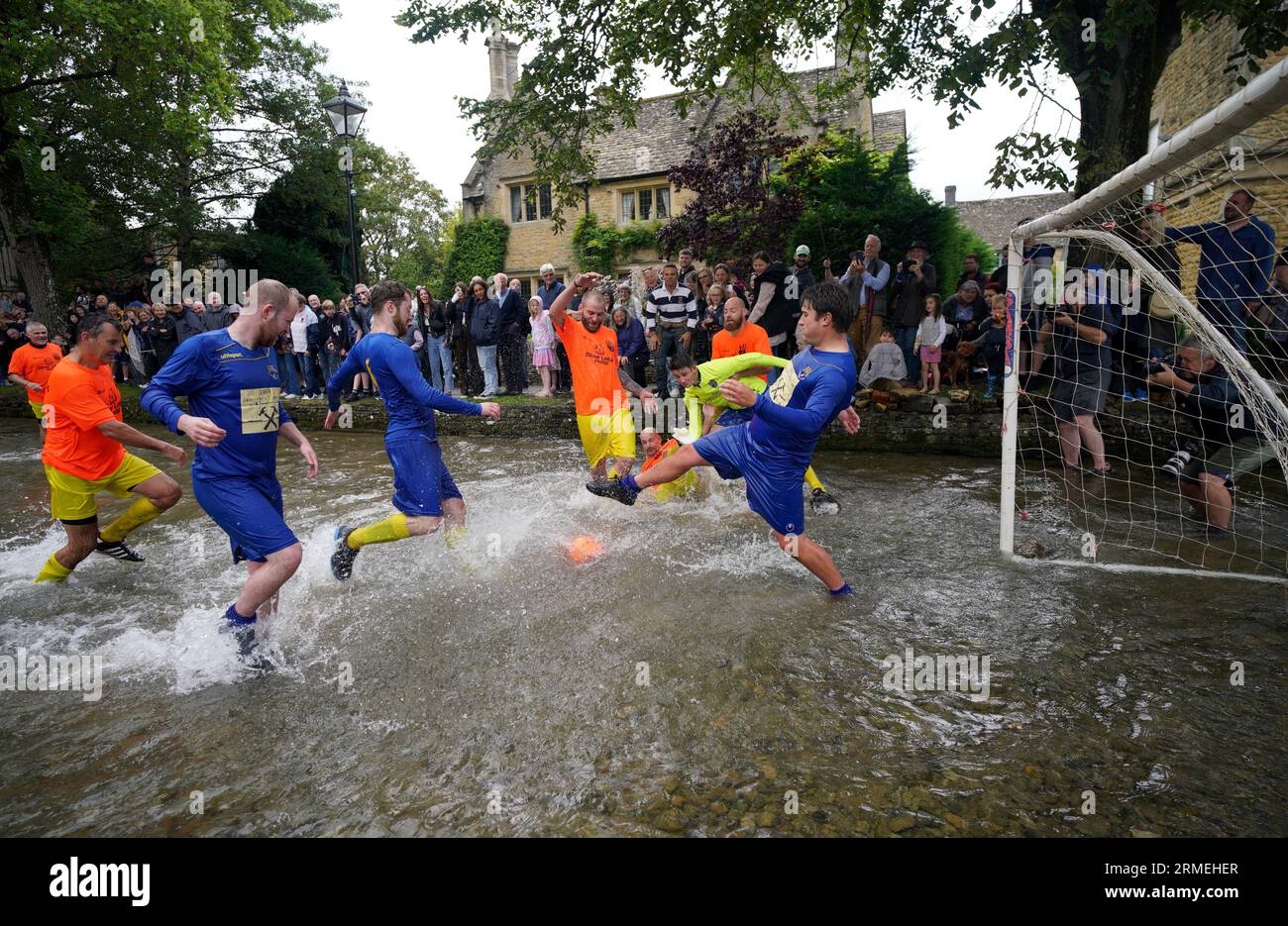 Footballers from Bourton Rovers fight for the ball during the annual ...