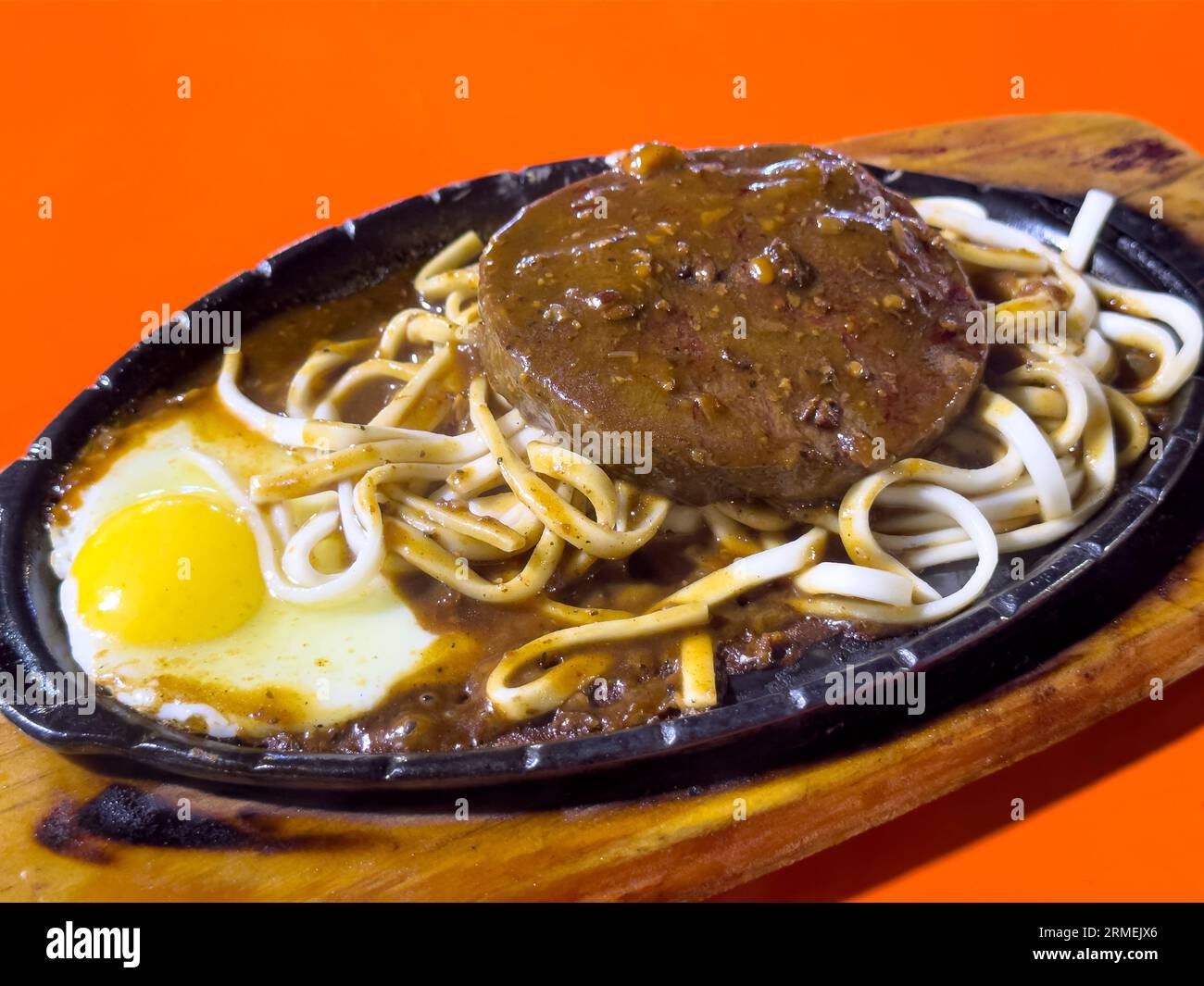 Taiwanese style special sizzling beef steak with noodles, egg and sauce ...