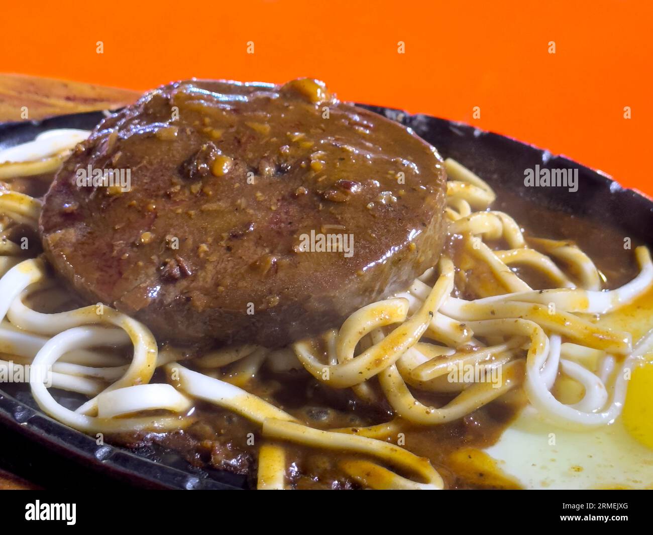 Taiwanese style special sizzling beef steak with noodles, egg and sauce ...