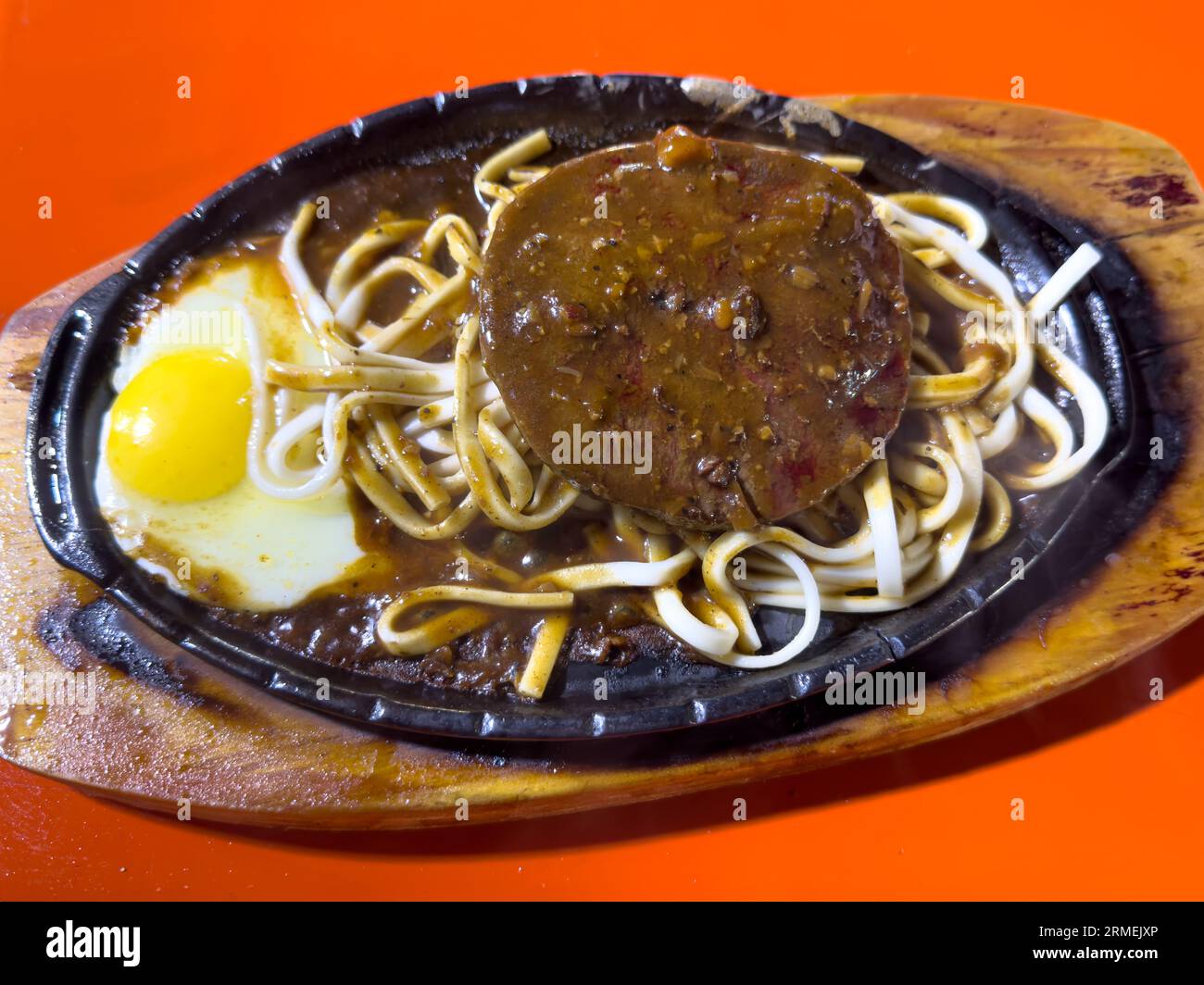 Taiwanese style special sizzling beef steak with noodles, egg and sauce ...