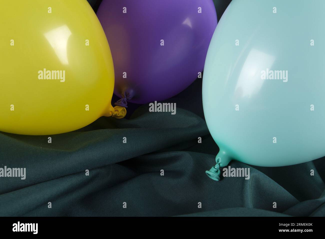 balloons in harmonious colors on a wavy green background. Minimal color ...