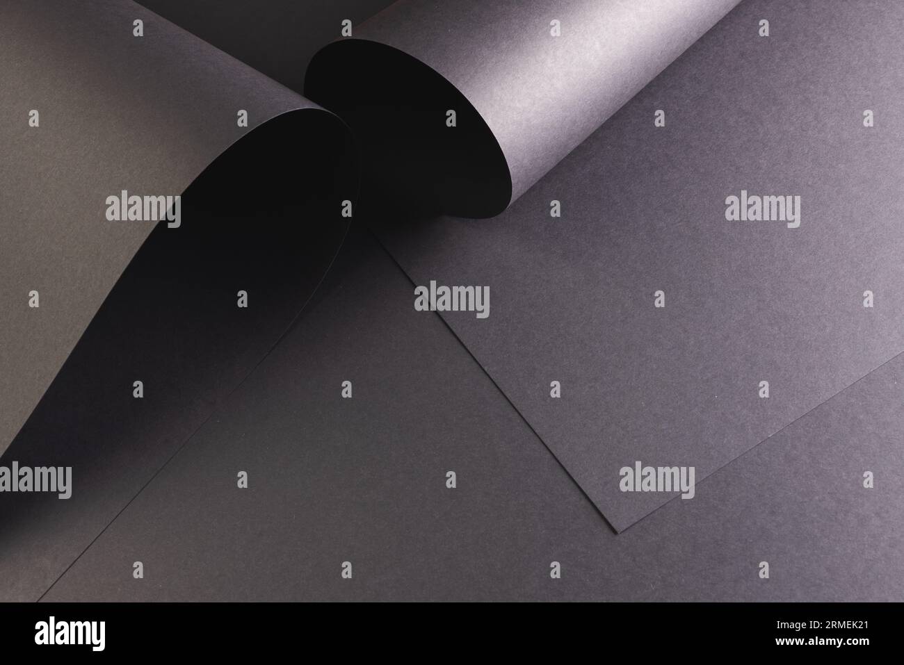 Close up of layers of pieces of black paper with copy space on black ...