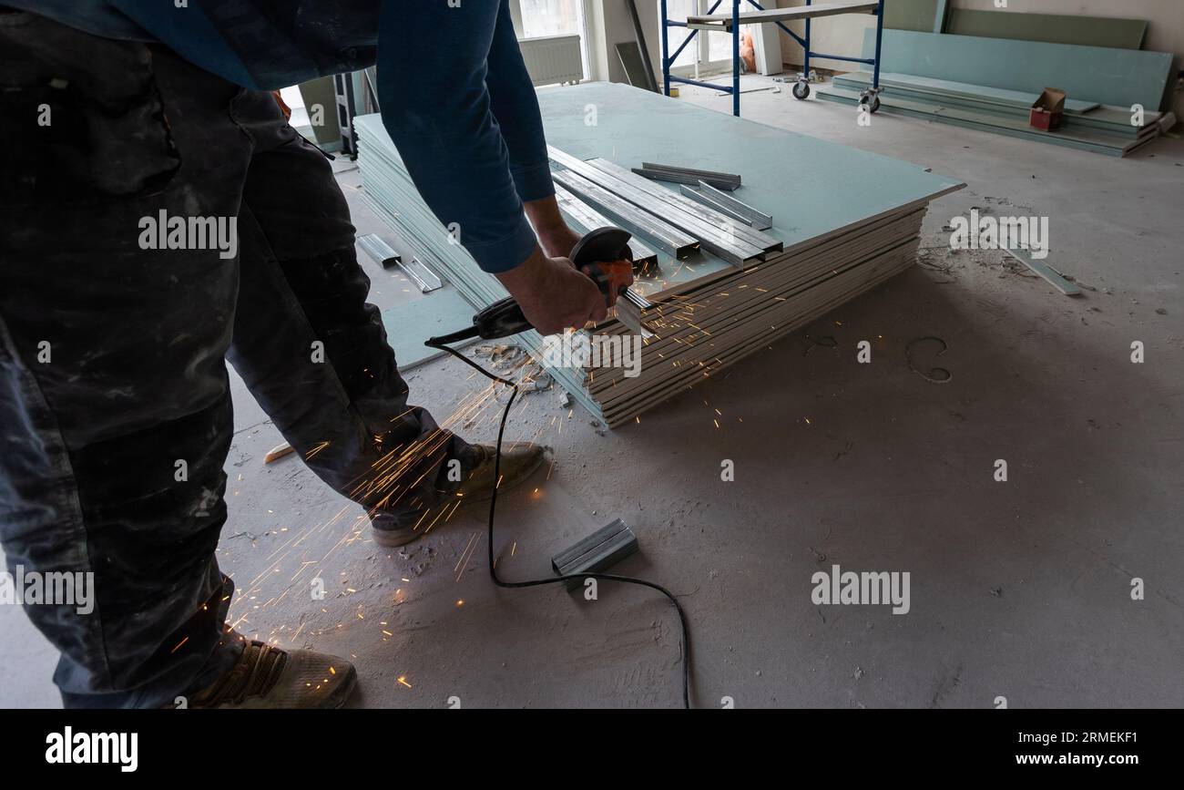 Workers fitting panel into frame of ceiling Stock Photo - Alamy