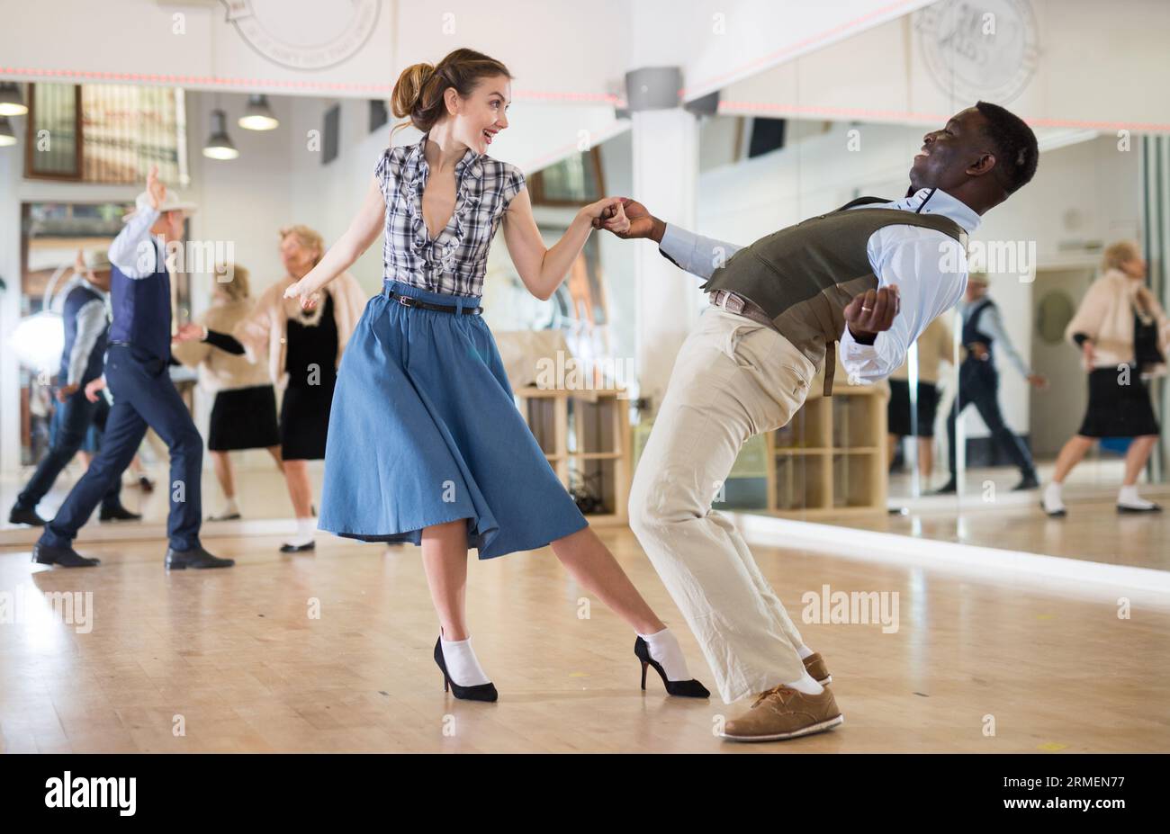 Woman with african man practising charleston dancing Stock Photo - Alamy