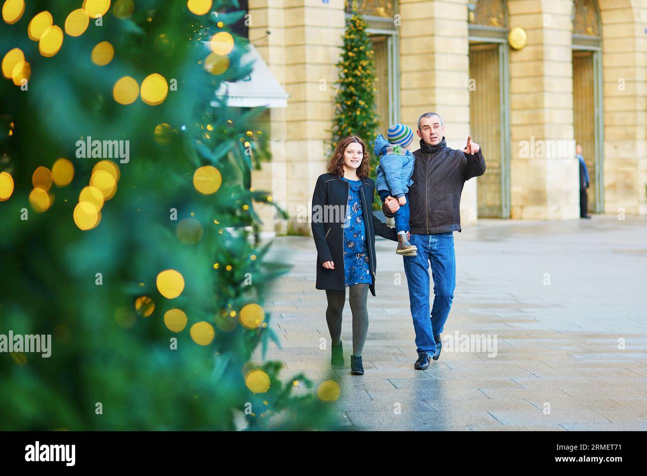 Happy family of three, young mother expecting a new baby, father and ...