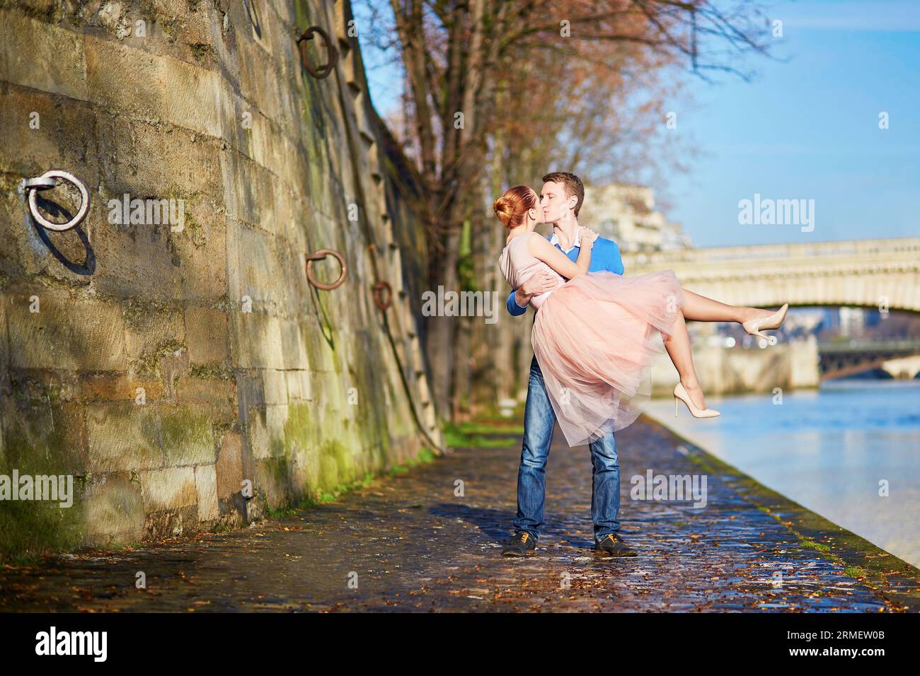 Beautiful romantic couple in Paris near the river Seine, man is ...