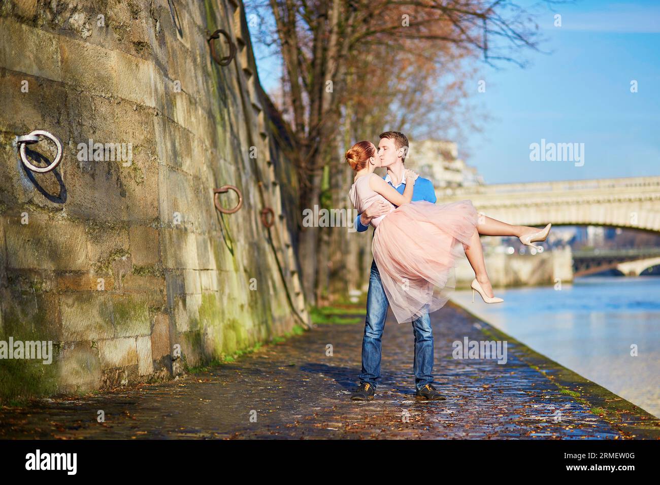 Beautiful romantic couple in Paris near the river Seine, man is ...
