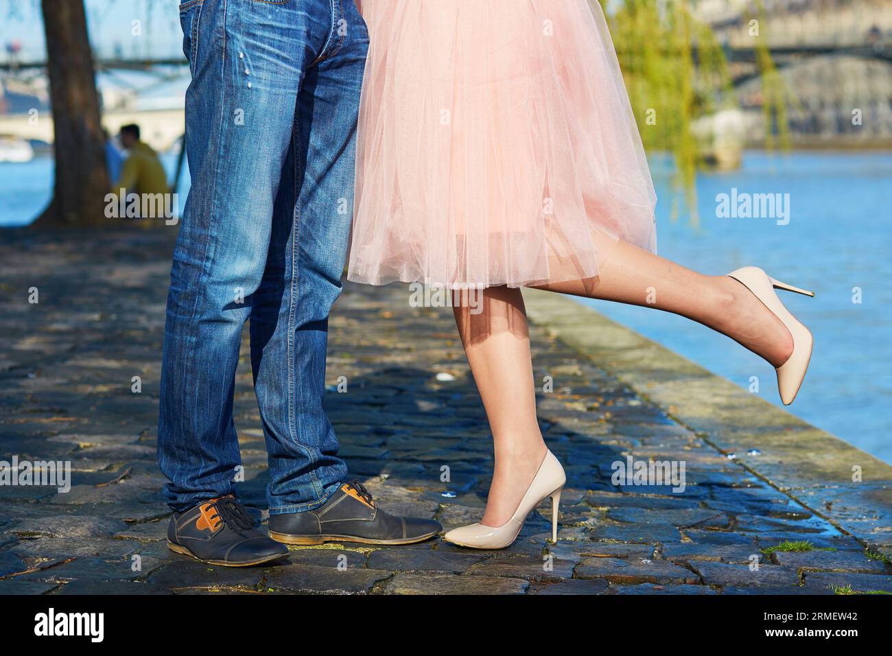 Closeup of male and female legs during a date. Romantic couple kissing ...