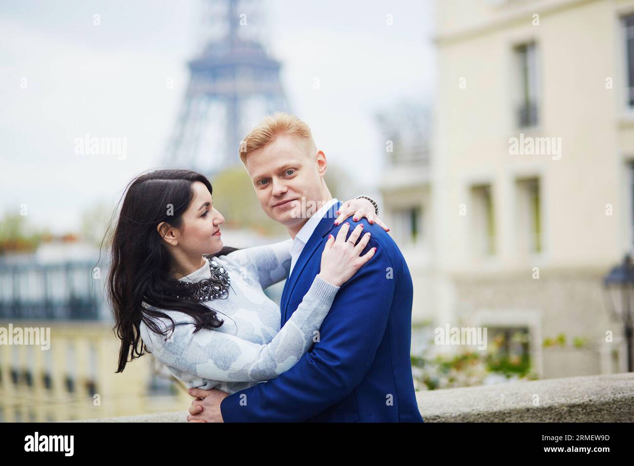 Happy couple enjoying scenic view on the Eiffel tower and Parisian ...