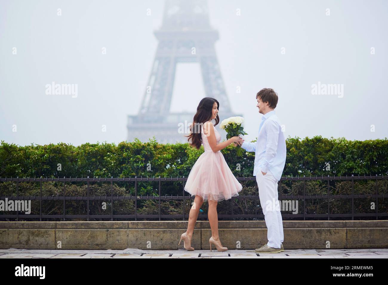 Beautiful romantic couple in love having a date near the Eiffel tower ...