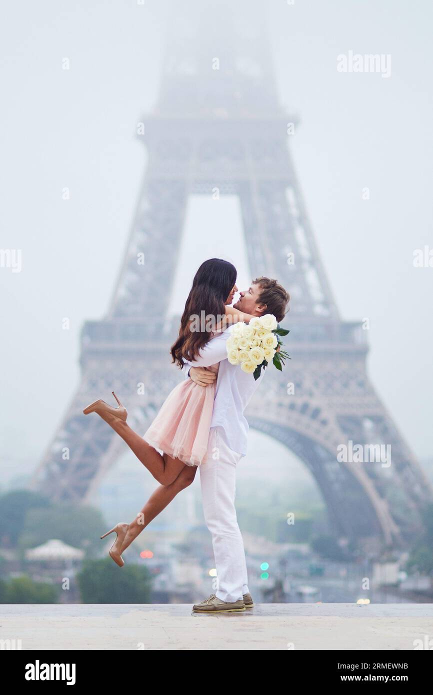 Beautiful romantic couple in love with bunch of white roses near the ...