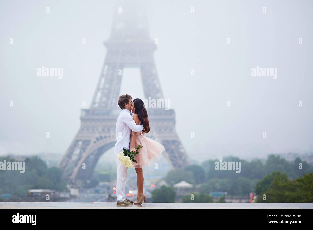 Beautiful romantic couple in love together near the Eiffel tower in ...