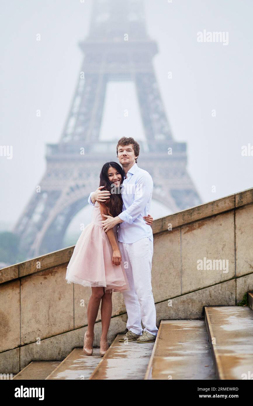 Beautiful romantic couple in love near the Eiffel tower in Paris on a ...