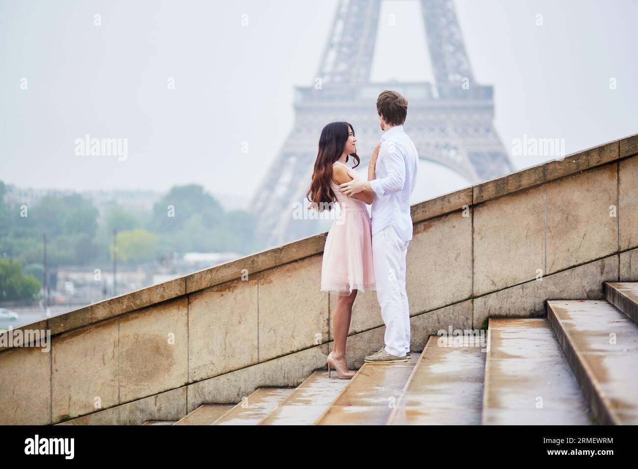 Beautiful romantic couple in love near the Eiffel tower in Paris on a ...