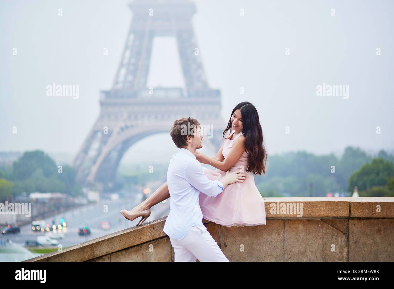 Beautiful romantic couple in love near the Eiffel tower in Paris on a ...
