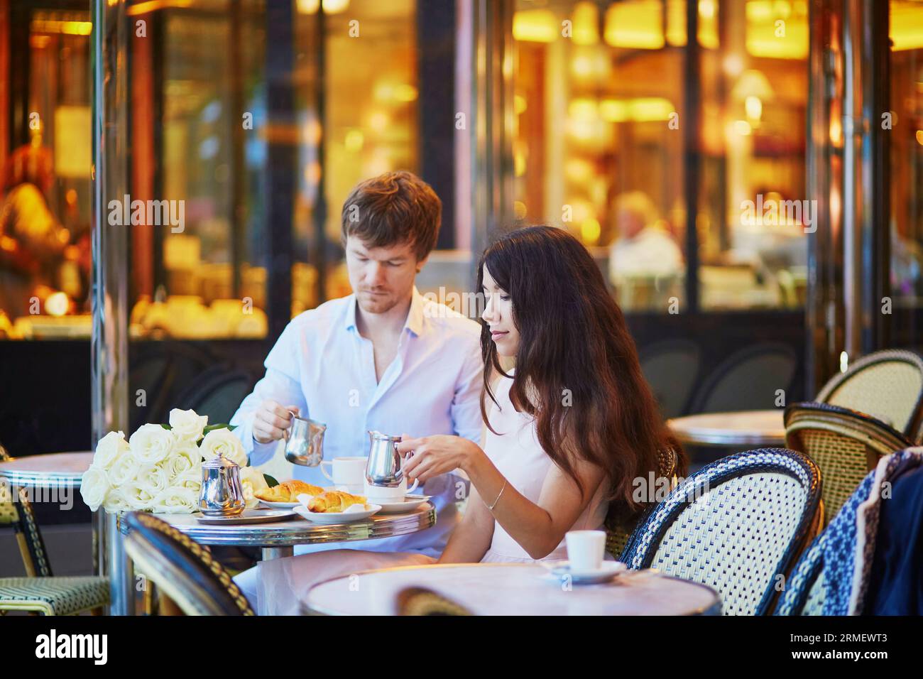 Romantic dating couple drinking coffee and eating traditional French ...