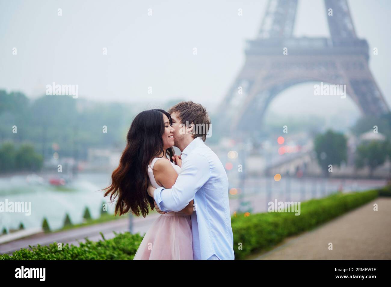 Beautiful romantic couple in love near the Eiffel tower in Paris on a ...