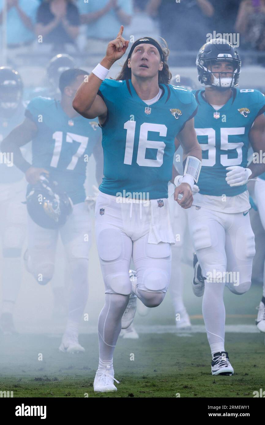 Jacksonville Jaguars quarterback Trevor Lawrence (16) runs onto the ...