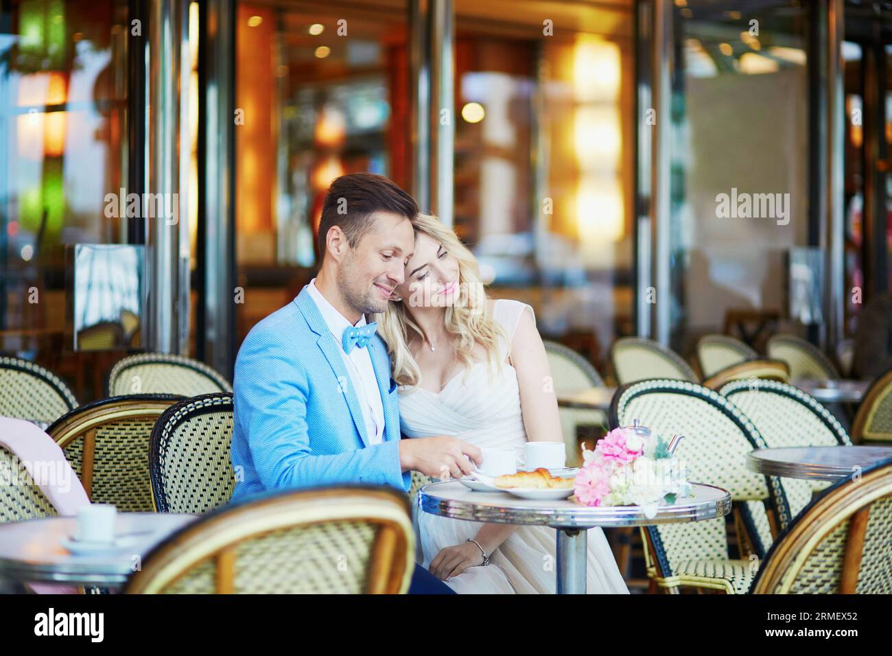 Just married couple in traditional Parisian cafe drinking coffee and ...