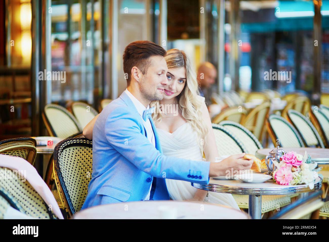 Just married couple in traditional Parisian cafe drinking coffee and ...