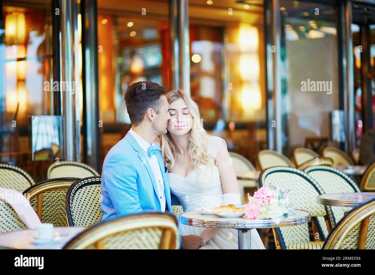 Just married couple in traditional Parisian cafe drinking coffee and ...