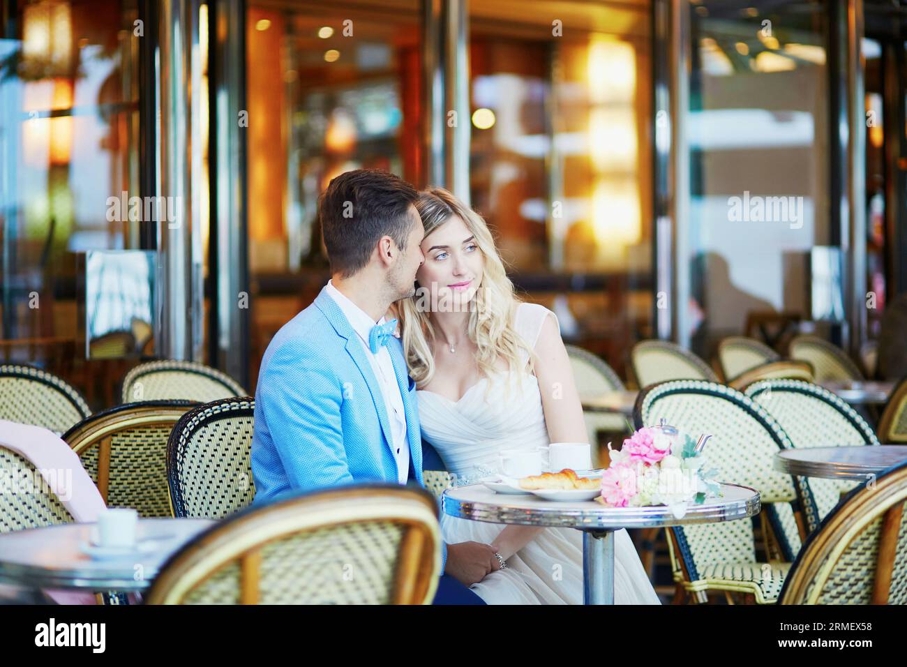 Just married couple in traditional Parisian cafe drinking coffee and ...