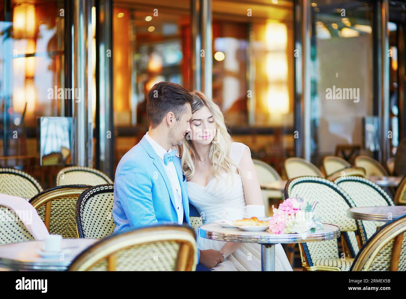 Just married couple in traditional Parisian cafe drinking coffee and ...