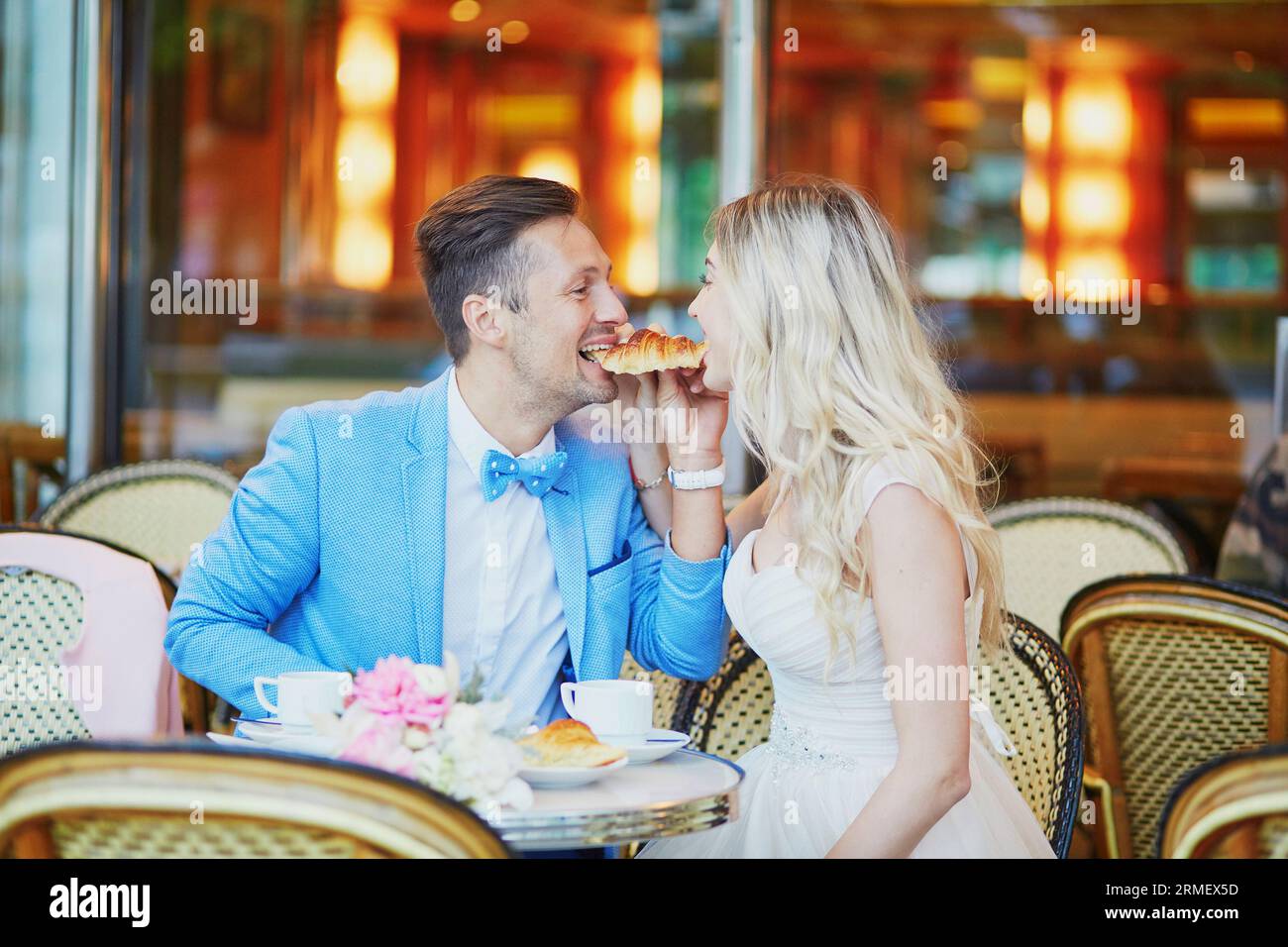 Just married couple in traditional Parisian cafe drinking coffee and ...