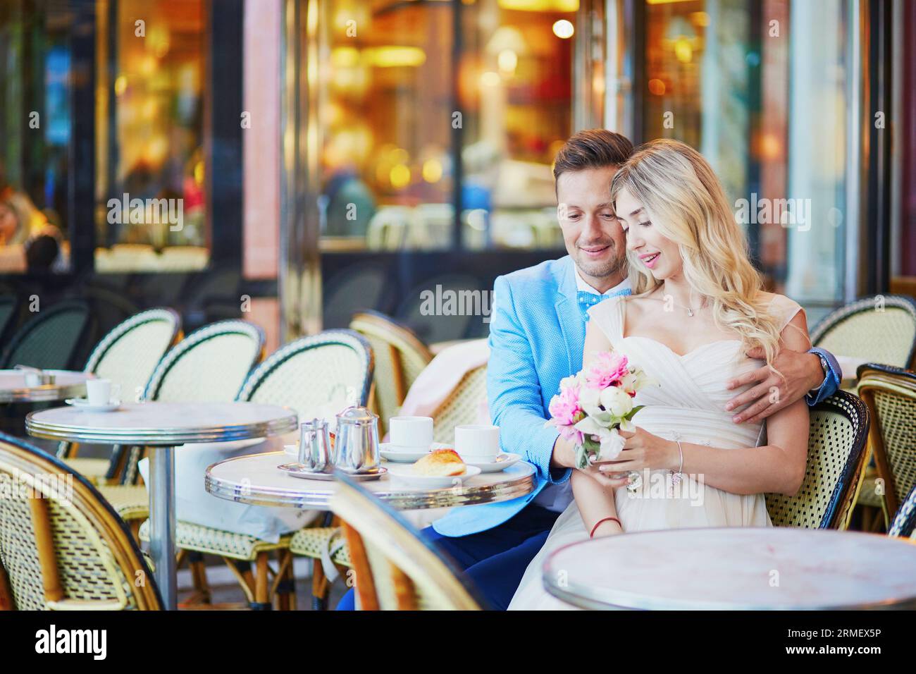Just married couple in traditional Parisian cafe drinking coffee and ...