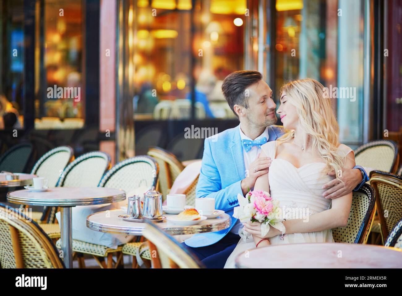 Just married couple in traditional Parisian cafe drinking coffee and ...