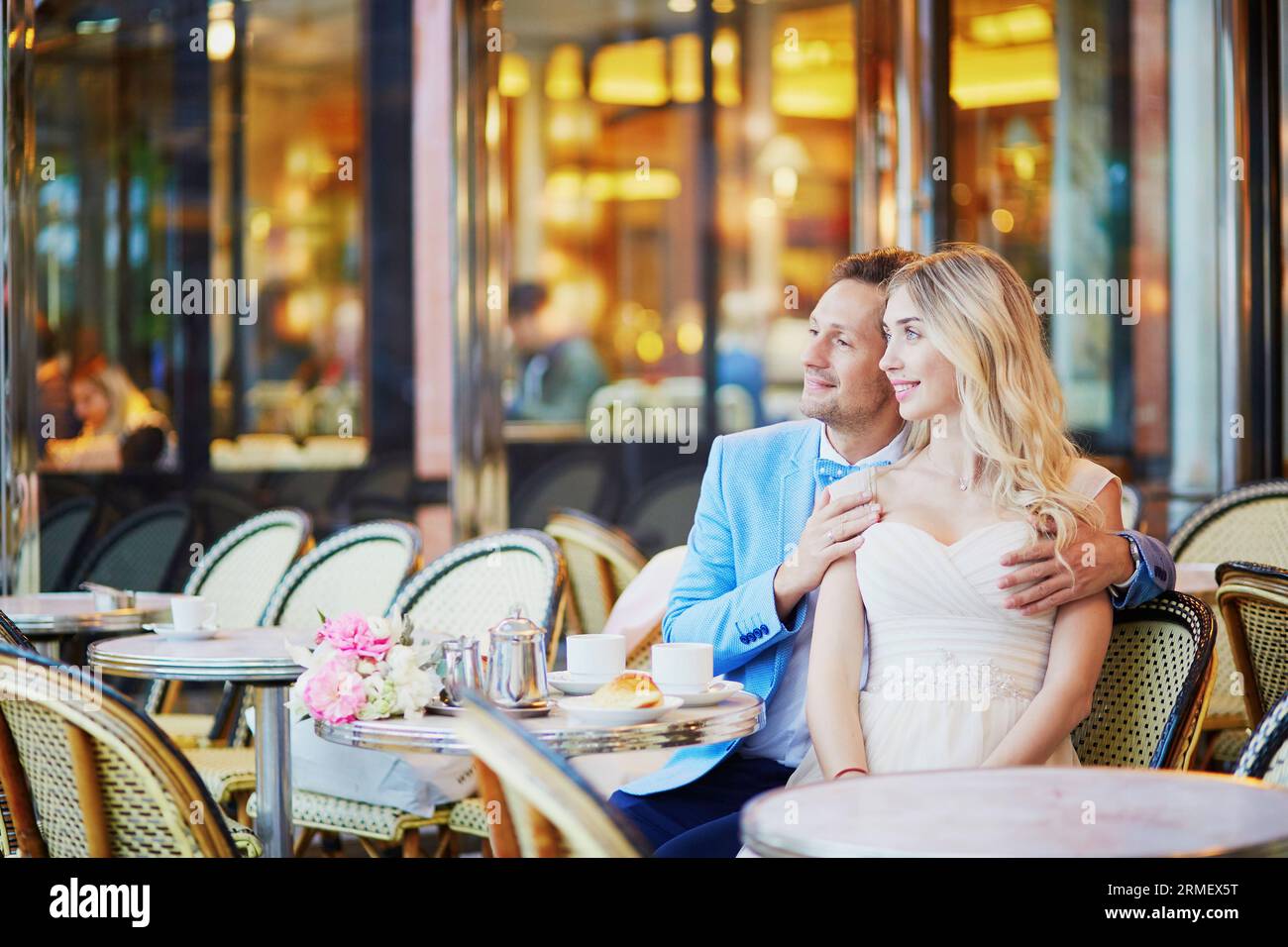 Just married couple in traditional Parisian cafe drinking coffee and ...