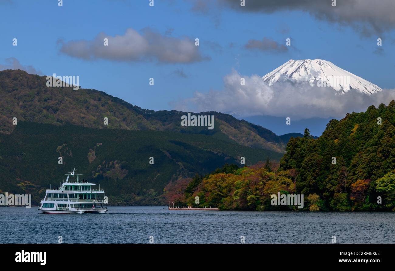 Mount fuji behind the mountains in the Ashi Lake, Hakone. A cruiser in ...