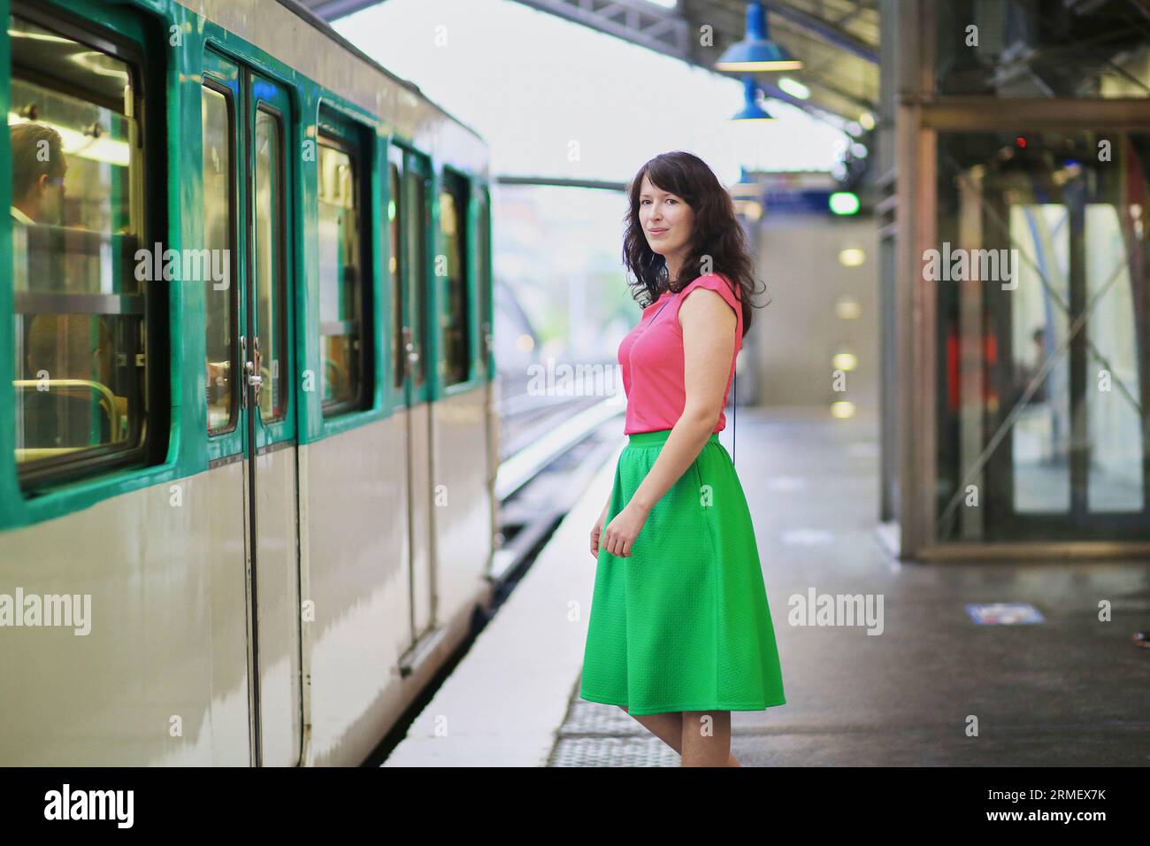 Young woman in Paris boarding a Parisian underground train. Local ...