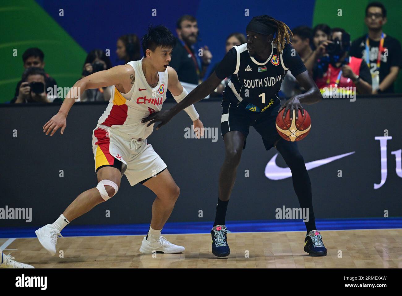 Rui Zhao (L) of China men basketball team and Nuni Omot (R) of South ...