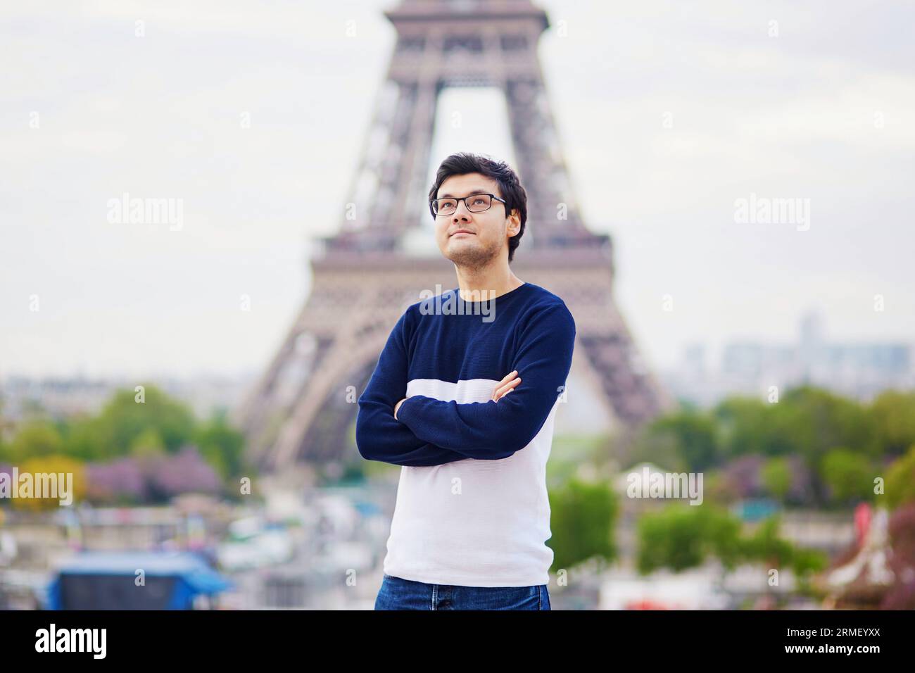 Handsome man in Paris in front of the Eiffel tower Stock Photo - Alamy