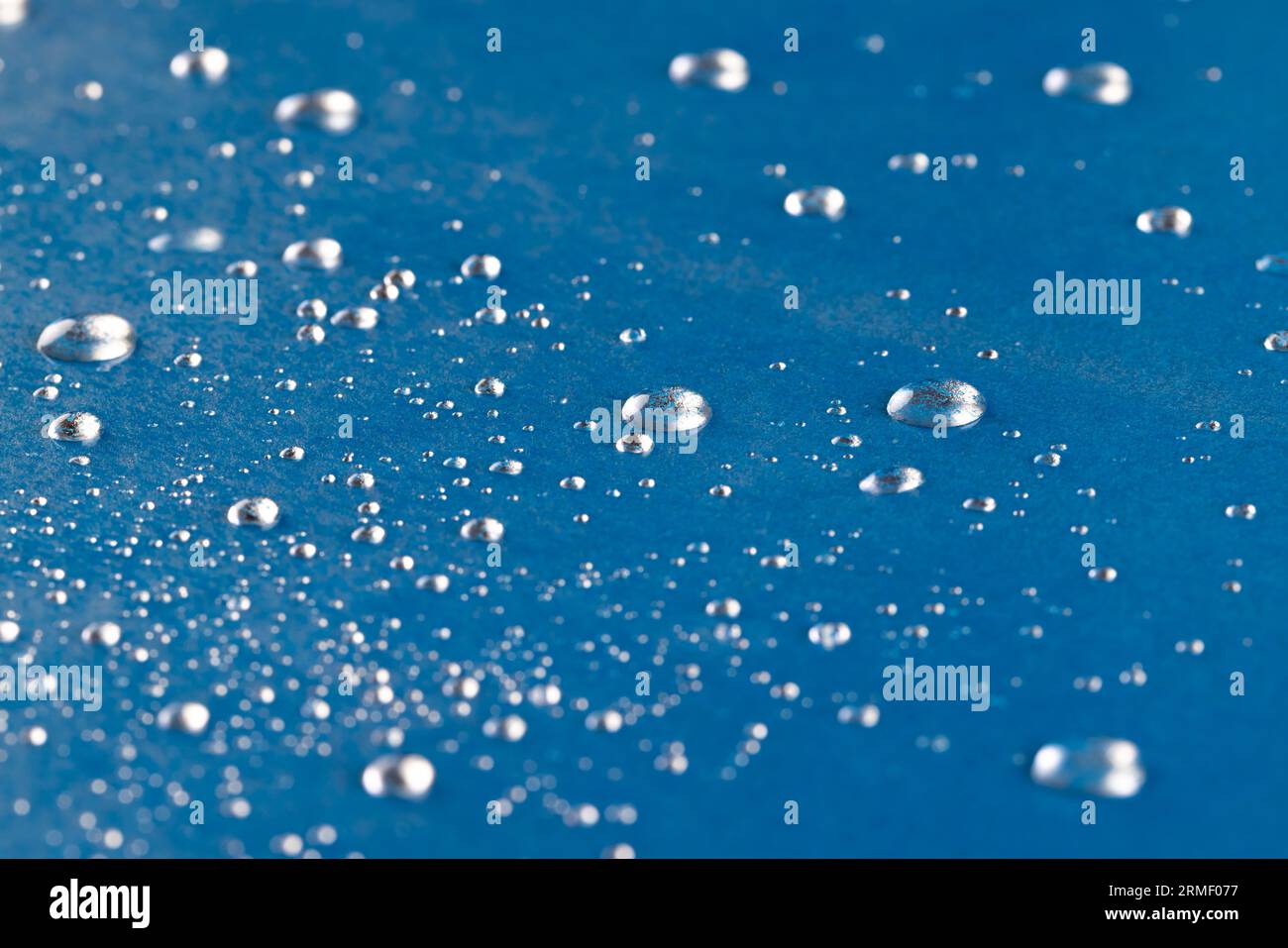 Micro close up of water drops with copy space on blue background Stock ...