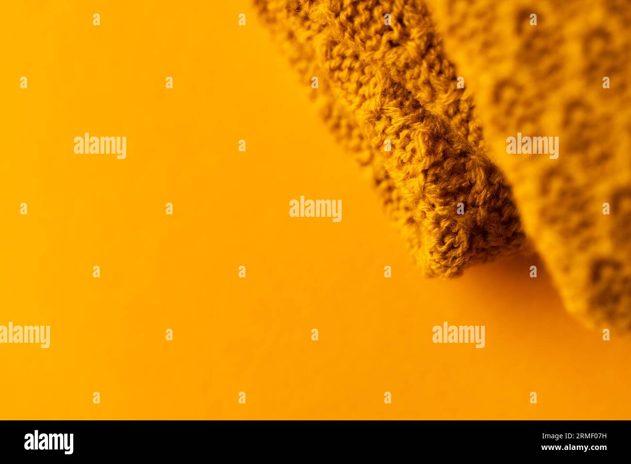 Micro close up of yellow wooly crochet fabric with copy space on yellow ...