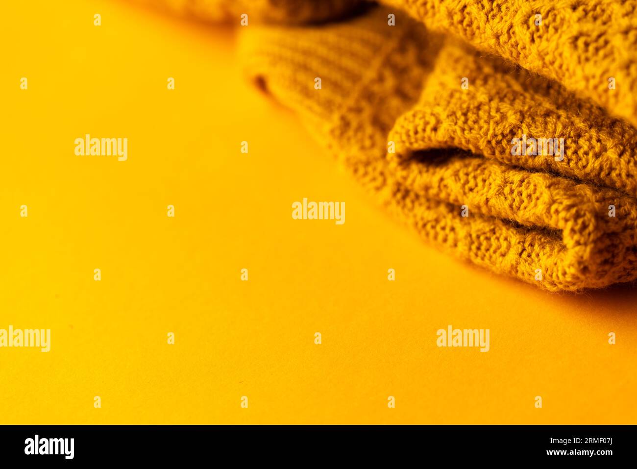 Micro close up of yellow wooly crochet fabric with copy space on yellow ...