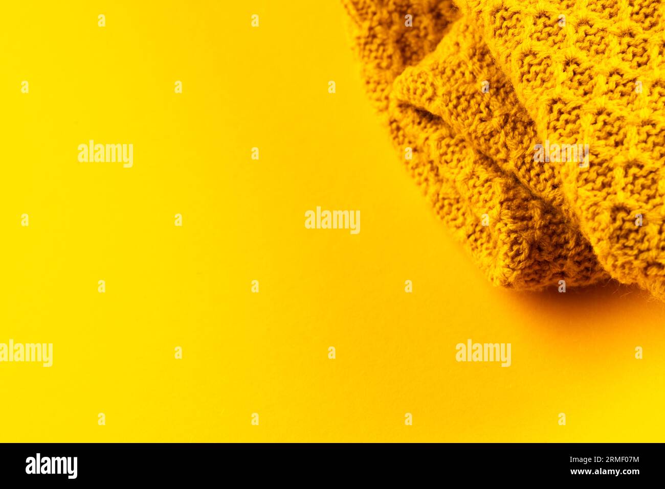Micro close up of yellow wooly crochet fabric with copy space on yellow ...